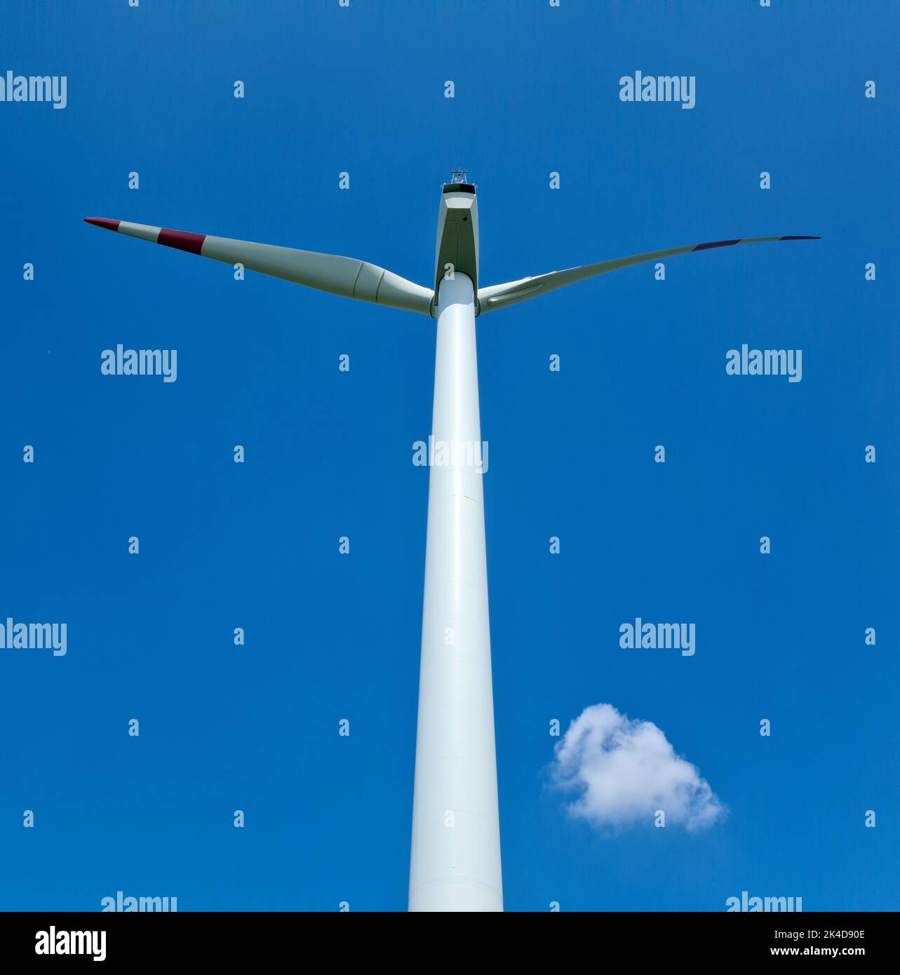 Detail of symmetric blades of a wind power plant in blue sky with one ...