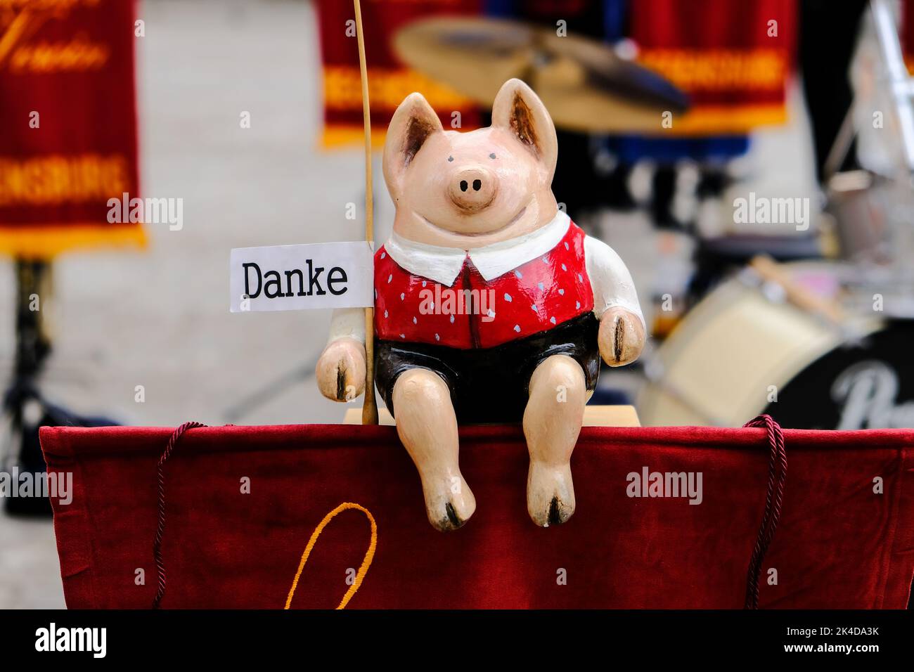 A closeup of a ceramic sitting pig figurine in a traditional german ...