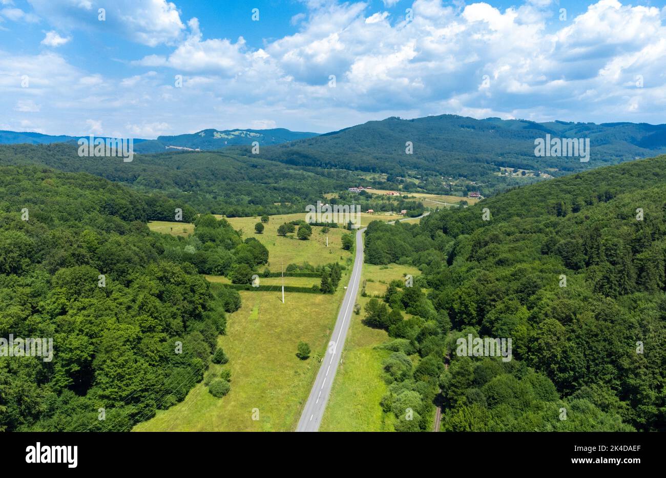 an aerial landscape of a road between hills in a rural area Stock Photo ...