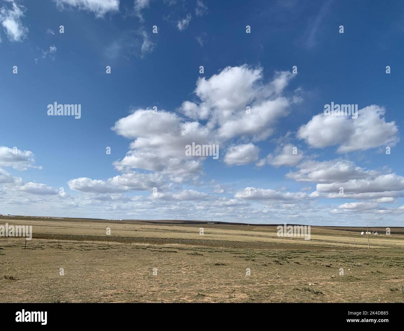 A beautiful view of Prairie large fields land under blue sky with ...