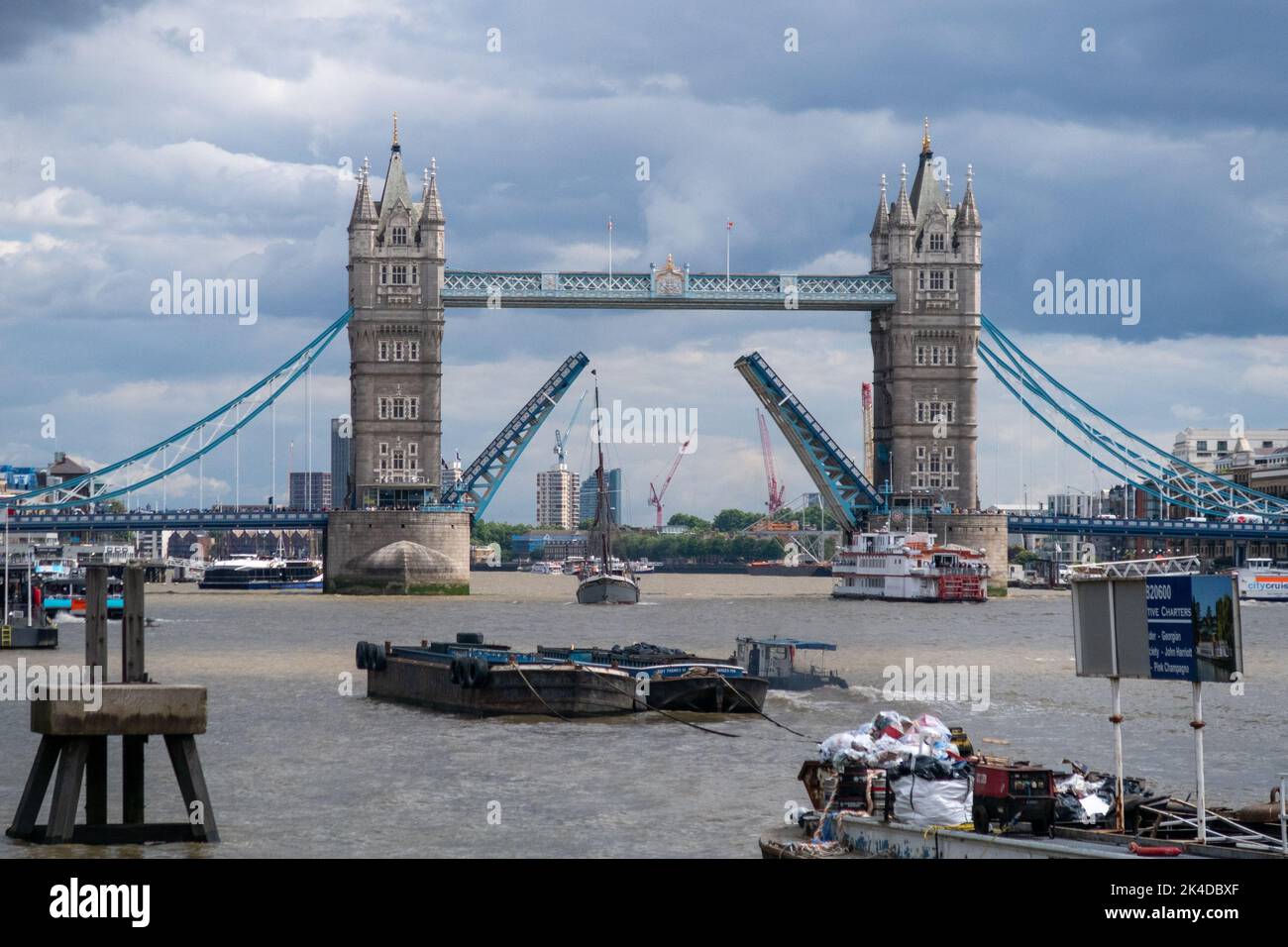The Tower Bridge opening to let a sailing ship through Stock Photo - Alamy