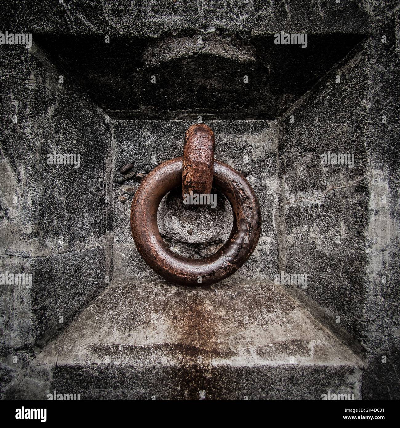 A rusty old iron ring in a stone wall Stock Photo - Alamy