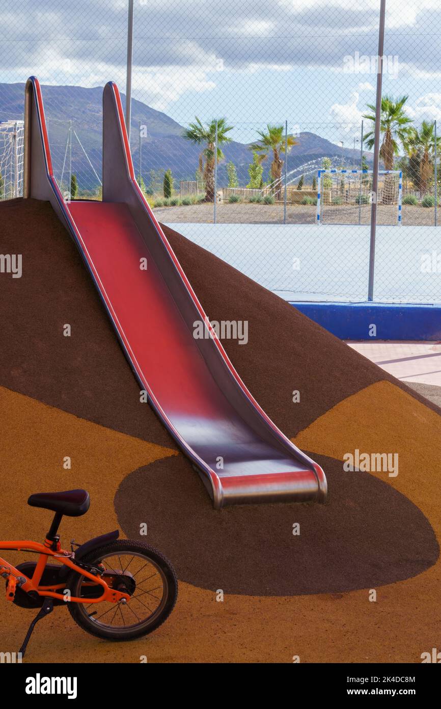 slide and bicycle in a playground, playground equipment for children ...