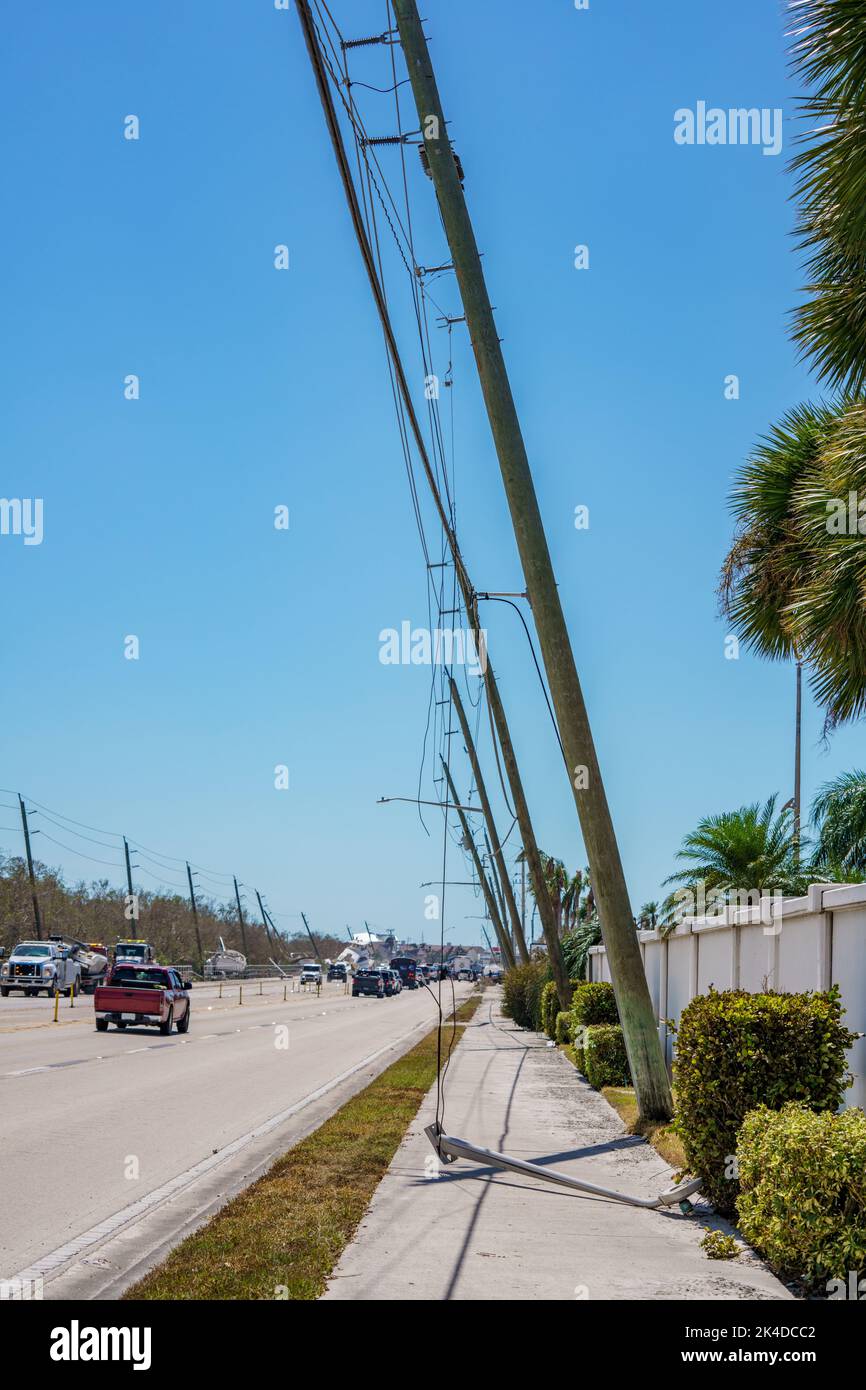 Wood electric pilons tilted from Hurricane Ian heavy storm winds along ... Wood electric pilons tilted from Hurricane Ian heavy storm winds along ...