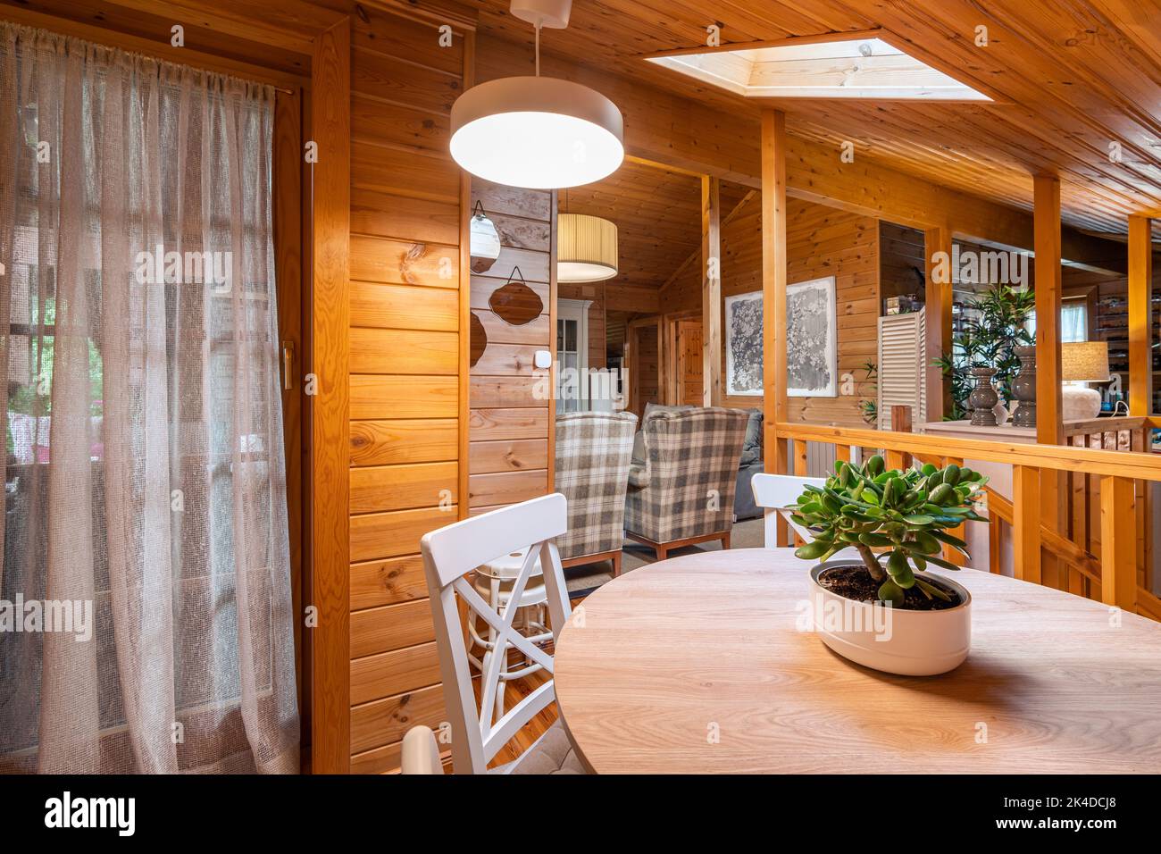 Dining room in a cozy wooden house. Rural style room with table, chairs ...