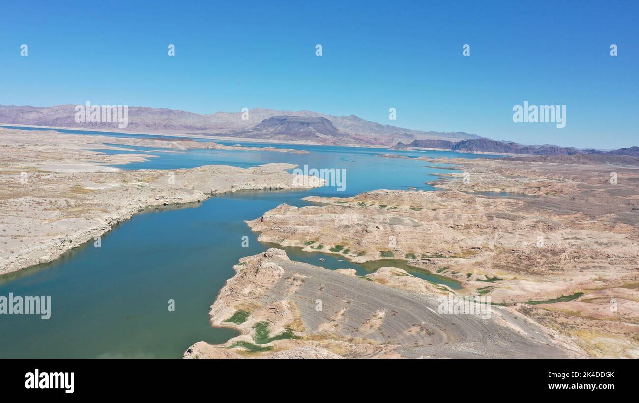 A high-angle shot of a part of lake Meade with sandy area around and ...