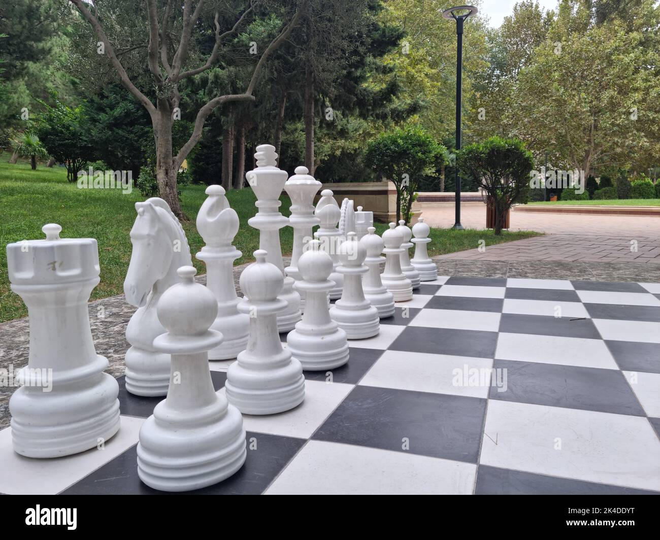 The white pieces of the big outdoor chess set at the park Stock Photo ...