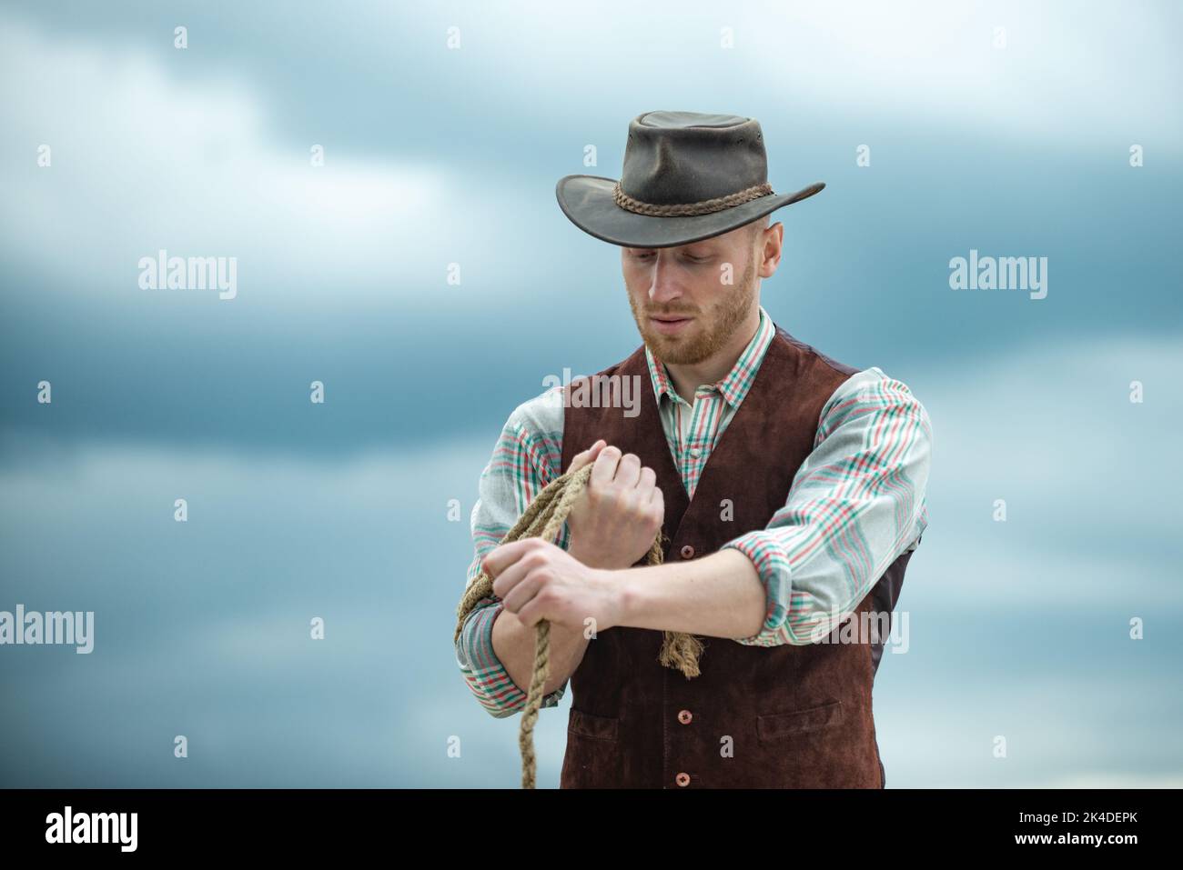 Cowboy farmer man in country side wearing western cowboy hat. American ...