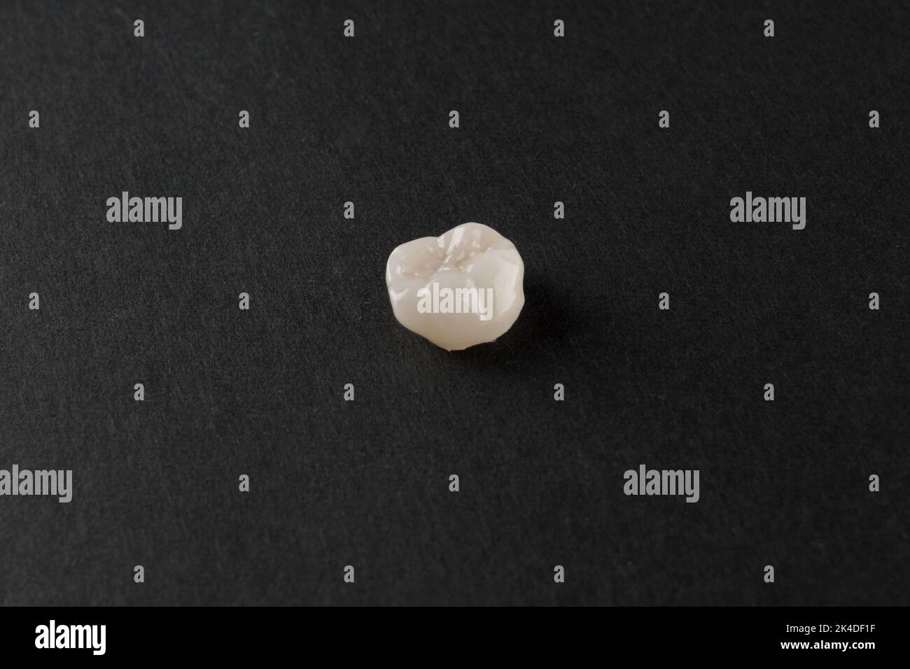 dental crown made of ceramics is located on a black background Stock ...
