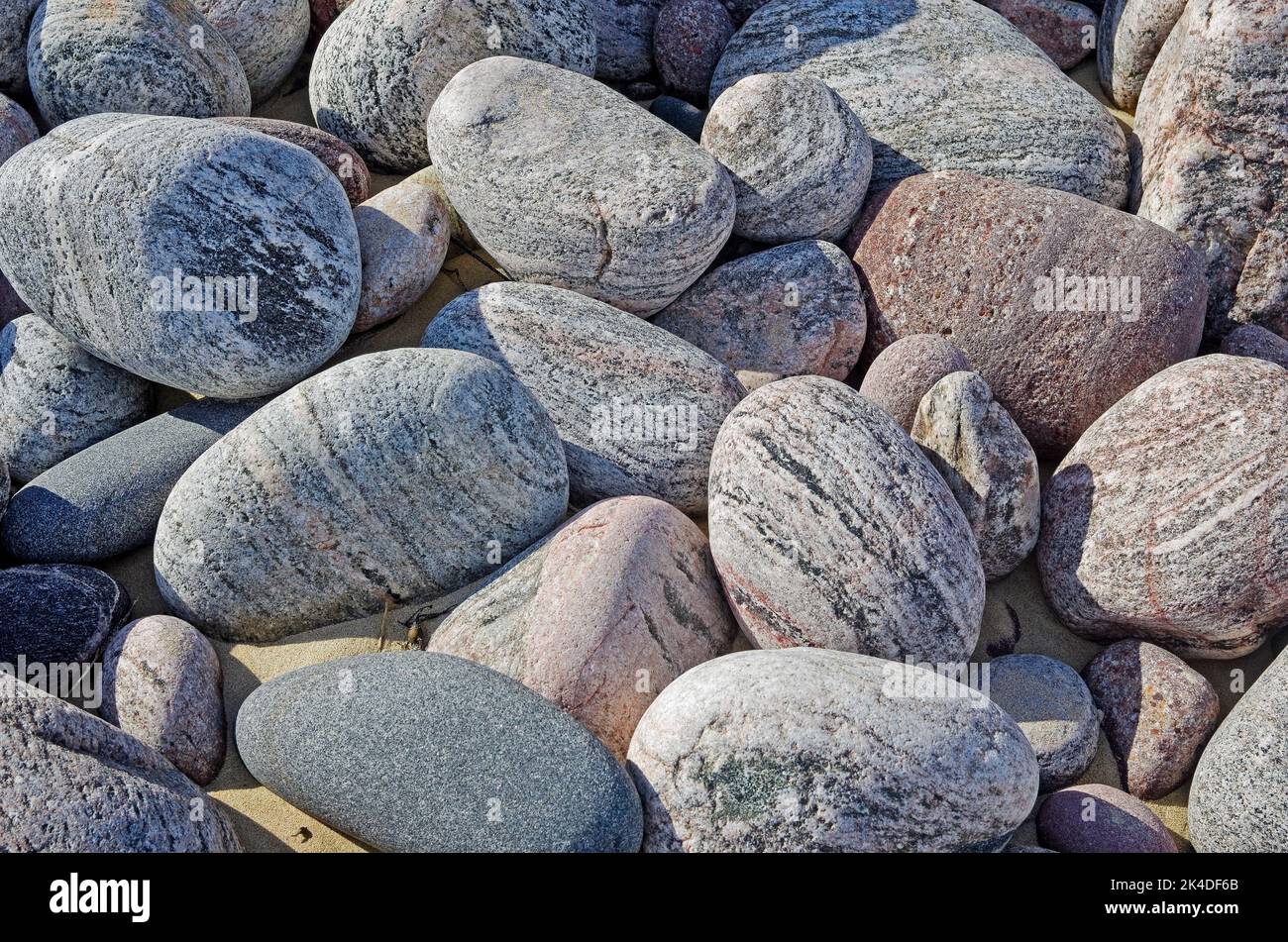 Beautiful textured coloured rocks and large stones deposited on the ...
