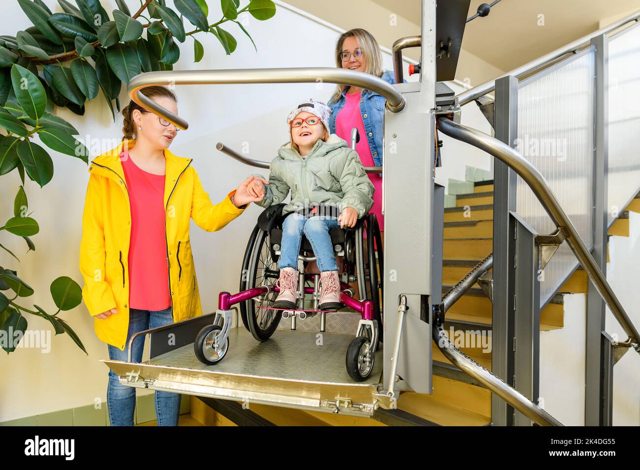 Mother with a young child living with cerebral palsy using electric ...