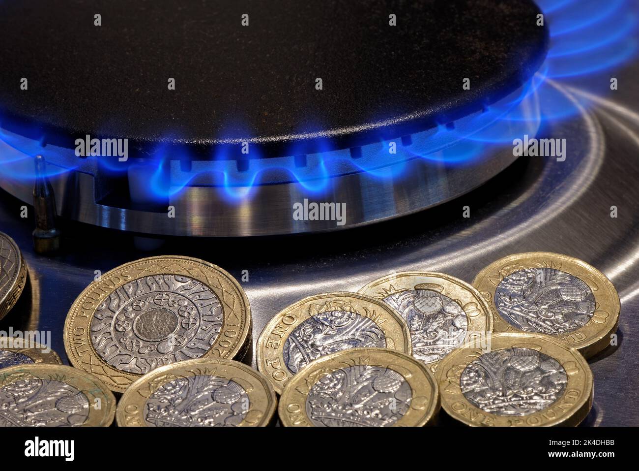 Coins surrounding a burning gas ring as an energy price rise concept ...