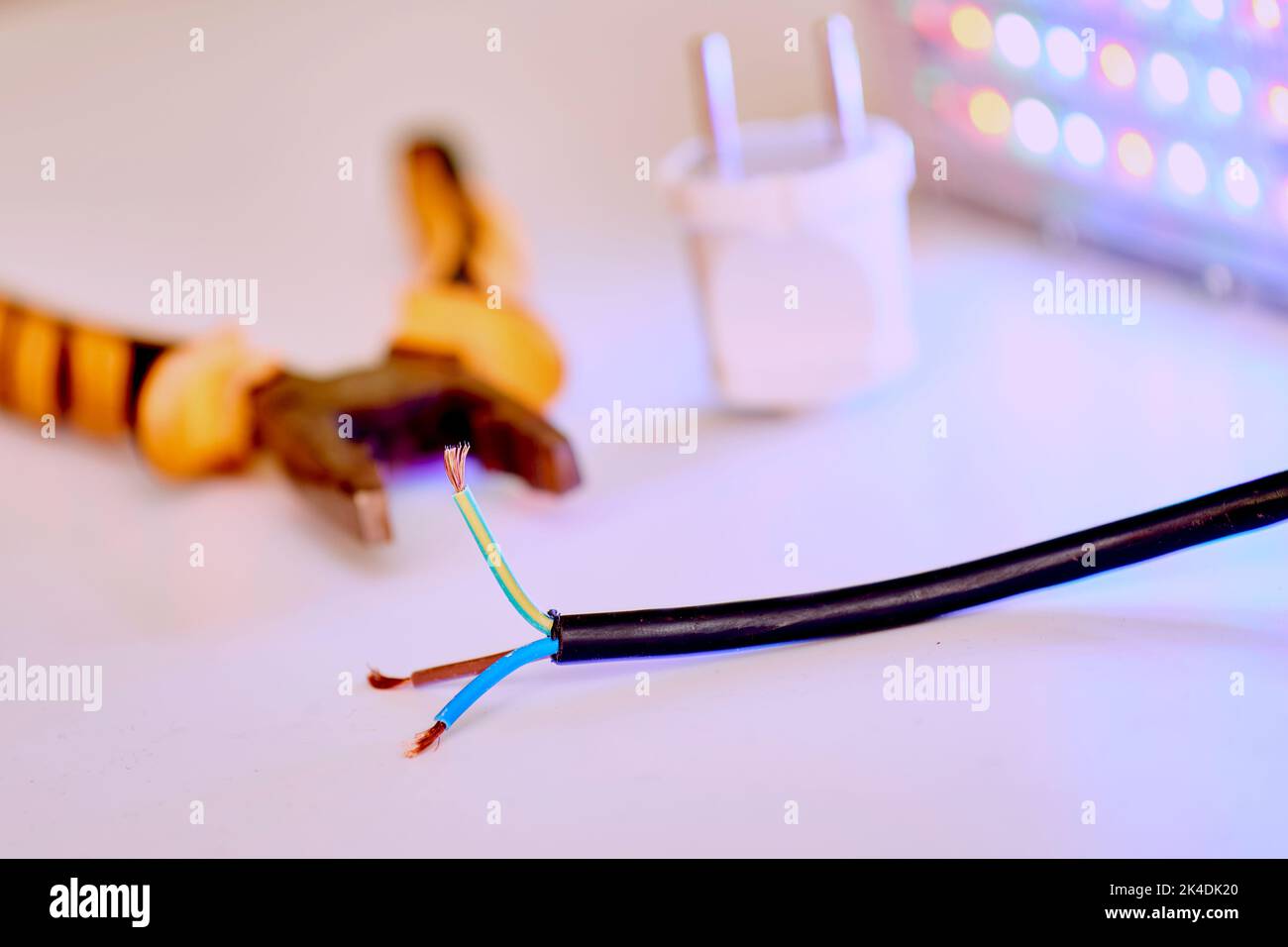 Black three-core electric cable, metalwork pliers and LED lamp Stock ...