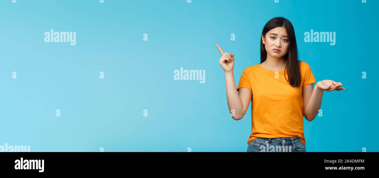 Troubled cute upset asian girl have problem asking your help, pointing ...