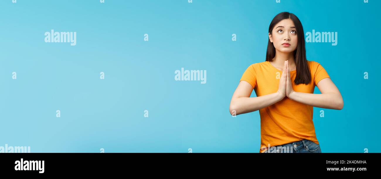 Serious-looking hopeful cute asian woman begging god hear prayers ...