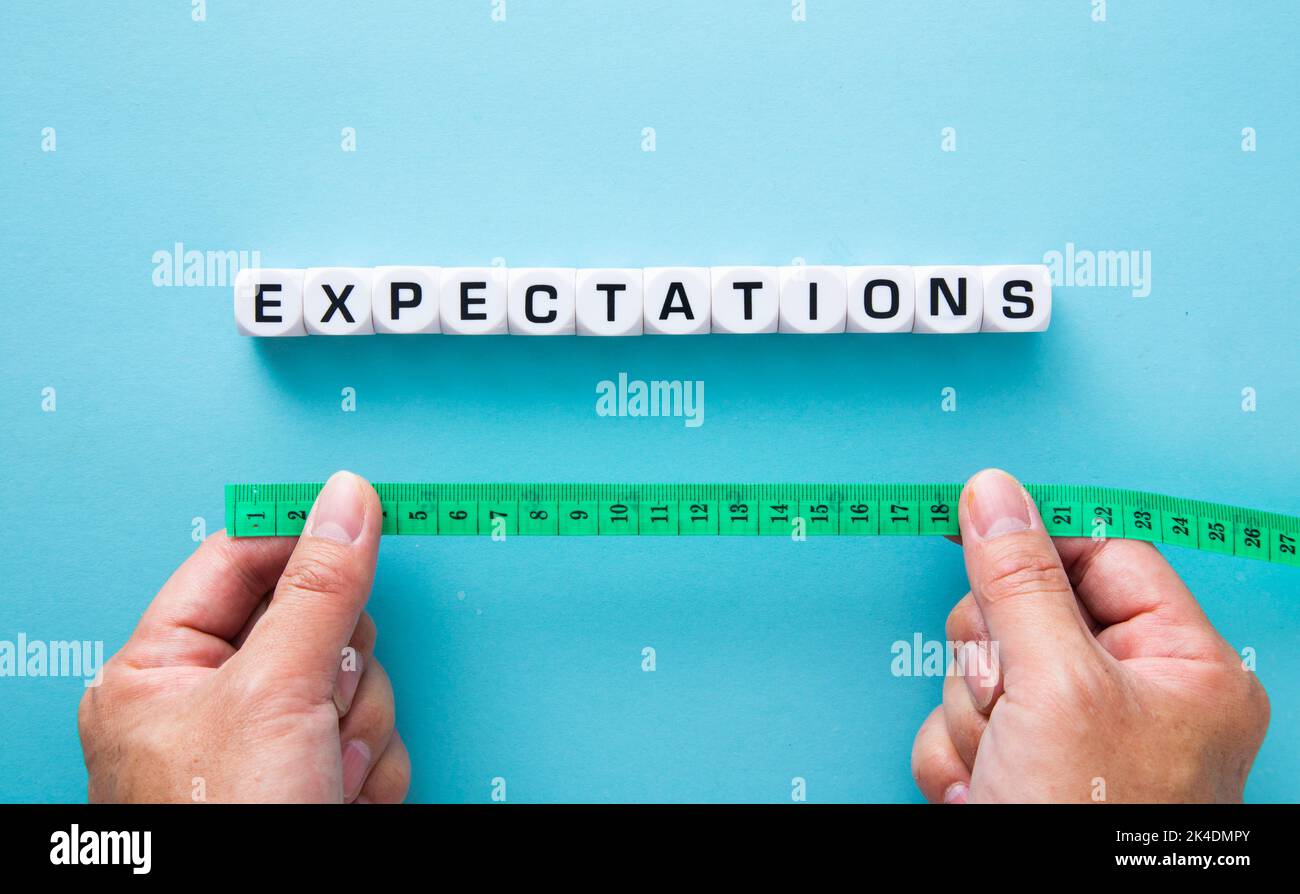 Tape measuring with Expectations word Stock Photo - Alamy