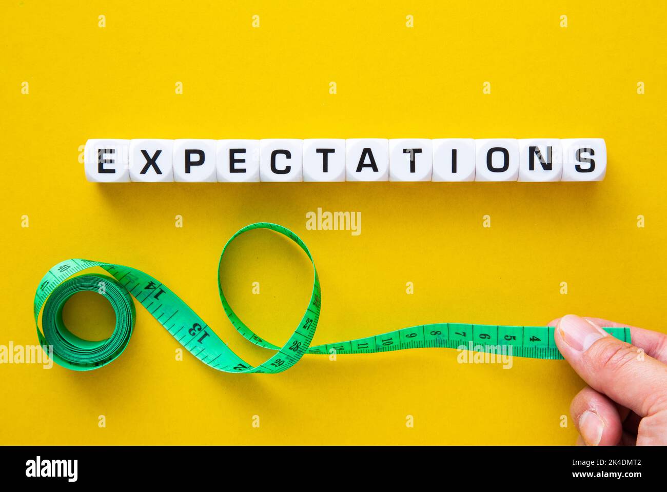 Tape measuring with Expectations word Stock Photo - Alamy