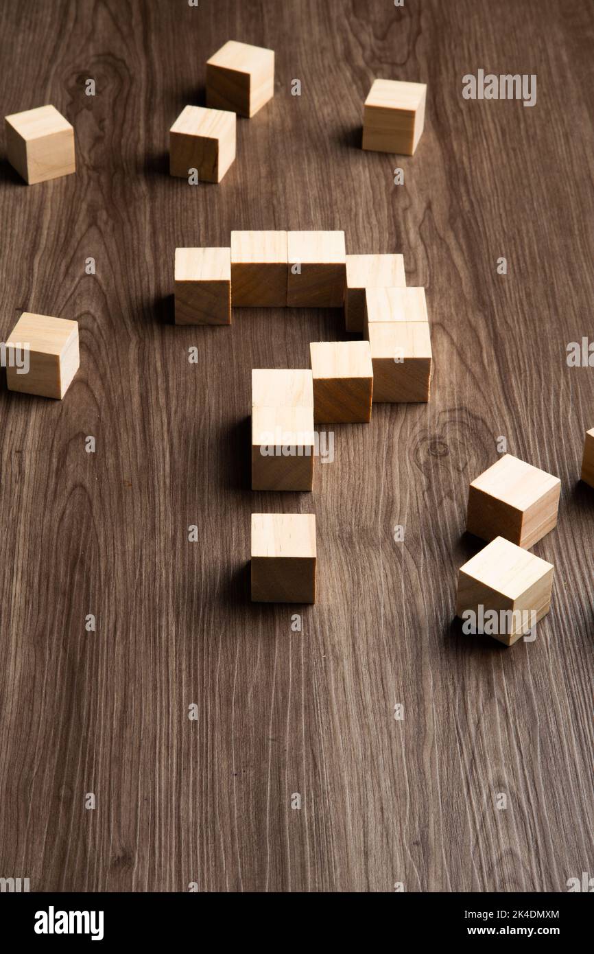 Question mark on wooden table background Stock Photo - Alamy