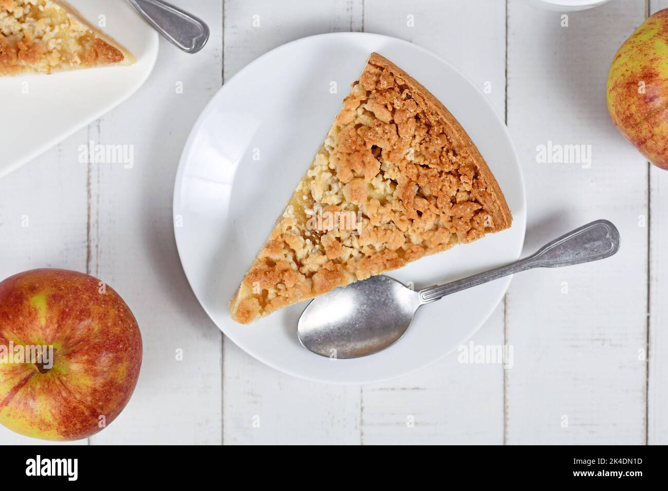 Top view of slice of traditional European apple pie with topping ...