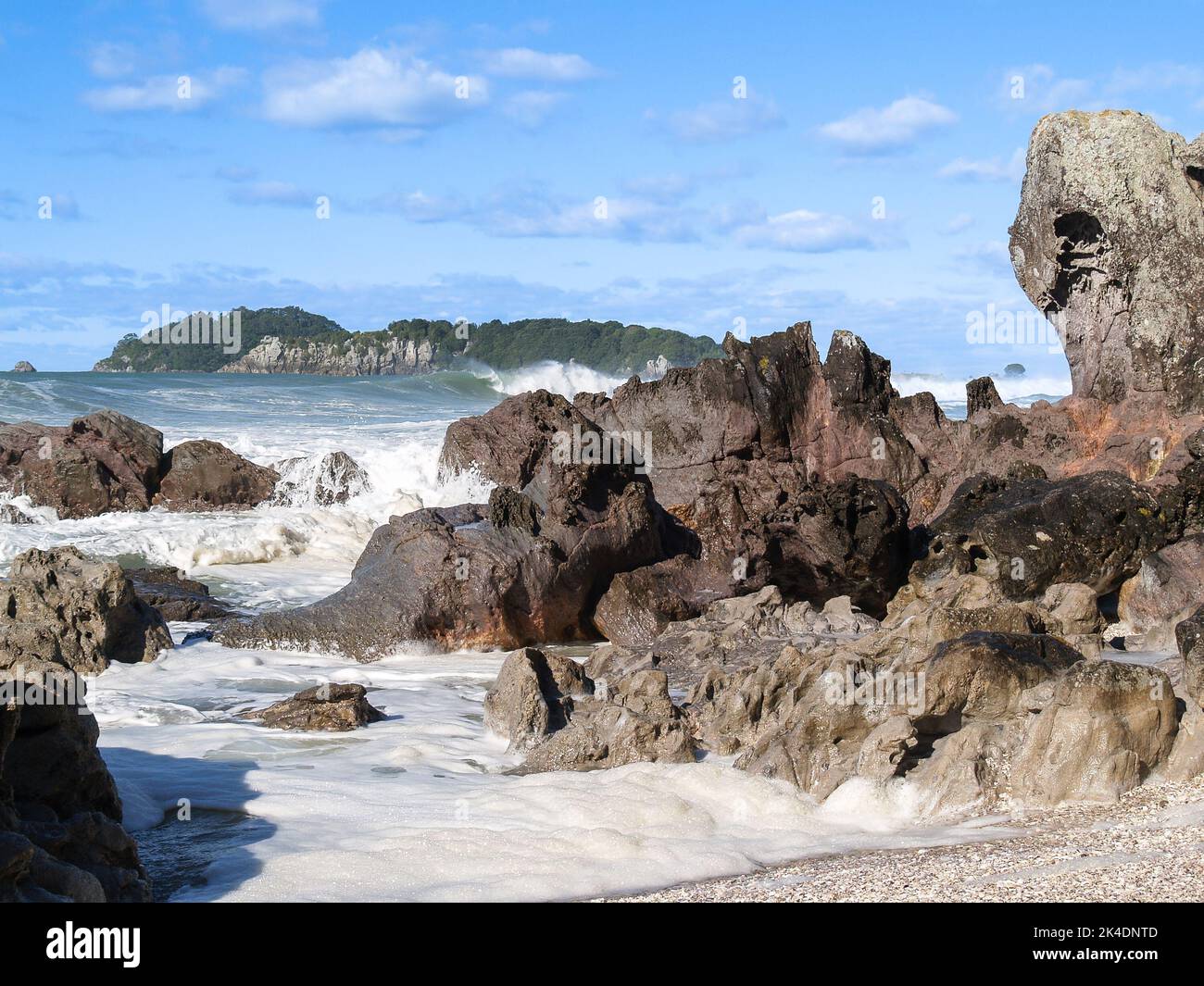 Waves breaking over and around rocky base Mount Maunganui Stock Photo ...