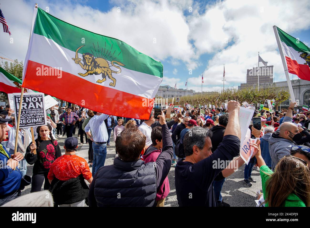 People rally outside the city hall of San Francisco with placards and ...