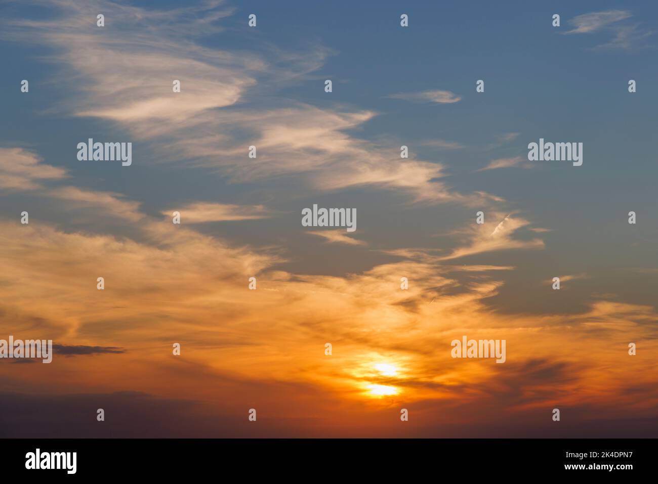 The setting sun lighting up the horizon Stock Photo - Alamy