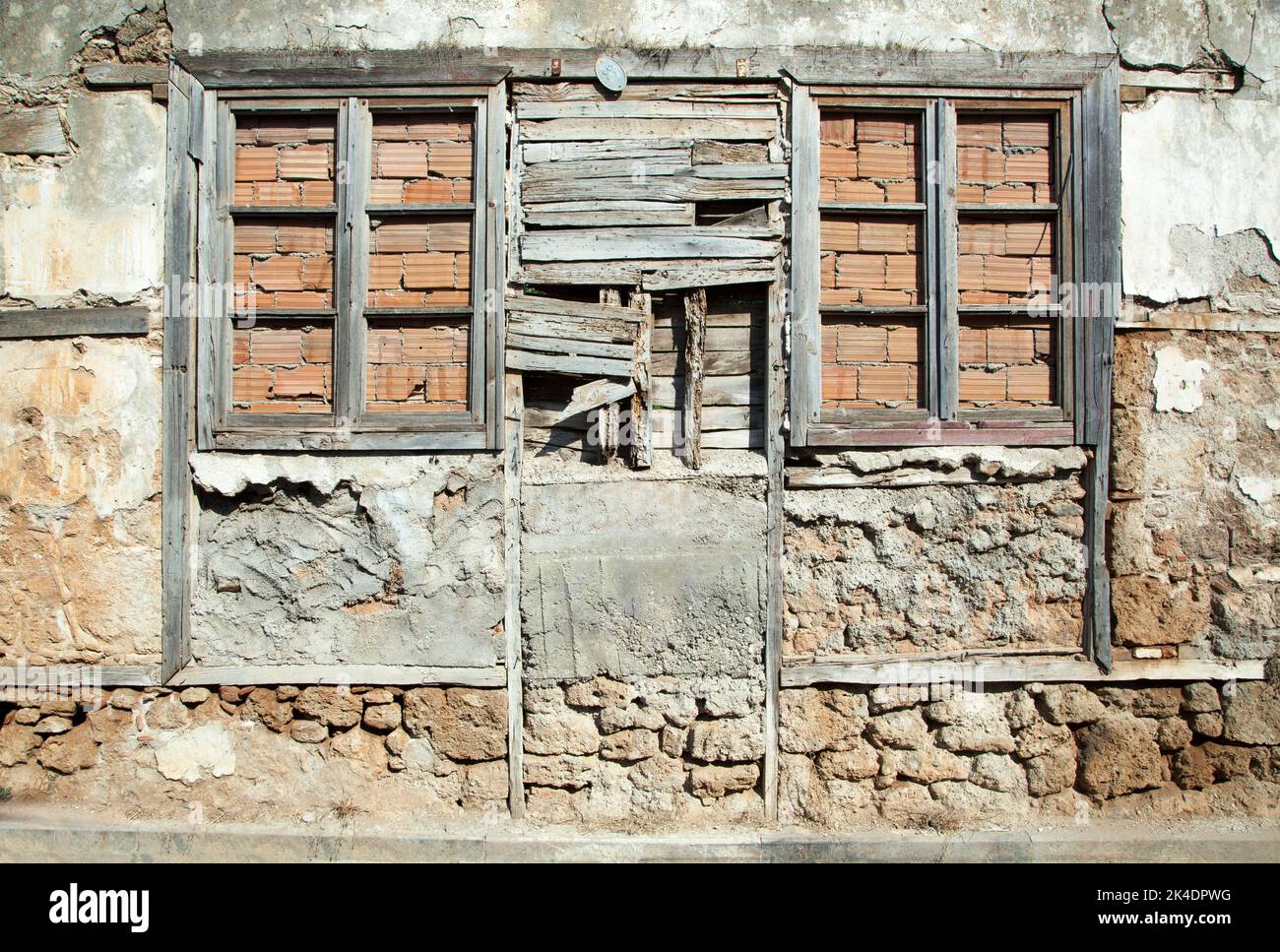 The permanently closed windows with bricks of an abandoned house in ...