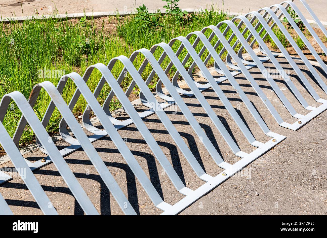 Metal parking lot for bicycles. Empty bicycle parking in city street ...