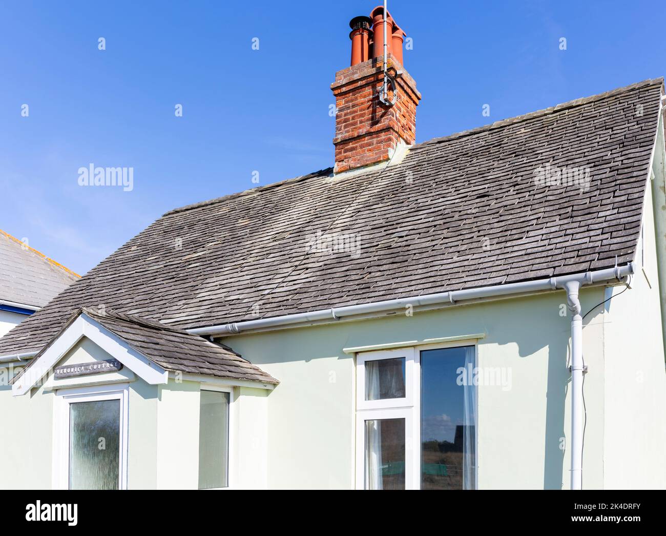 Wooden shingles tiking on roof of house at Shingle Street, Suffolk ...