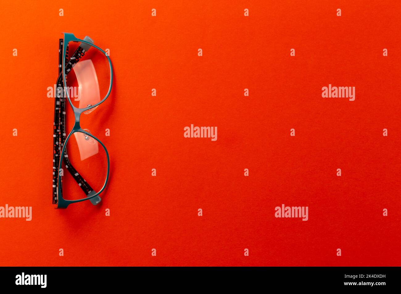 Stylish eyeglasses over orange background. Glasses selection, eye test ...