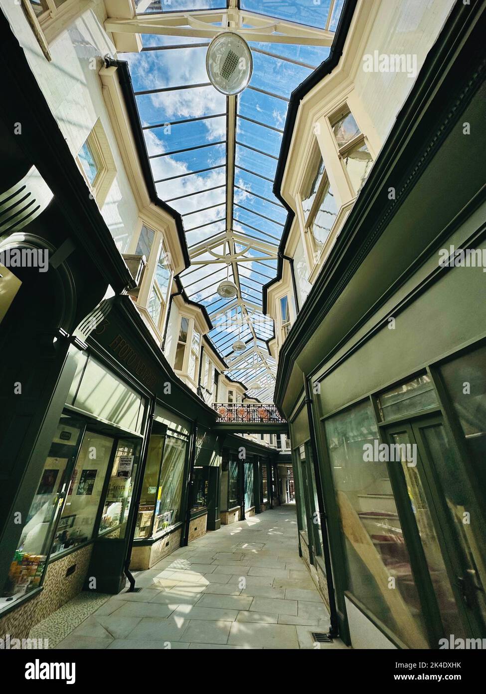 A low-angle shot of an empty path in a town shopping center on a sunny ...