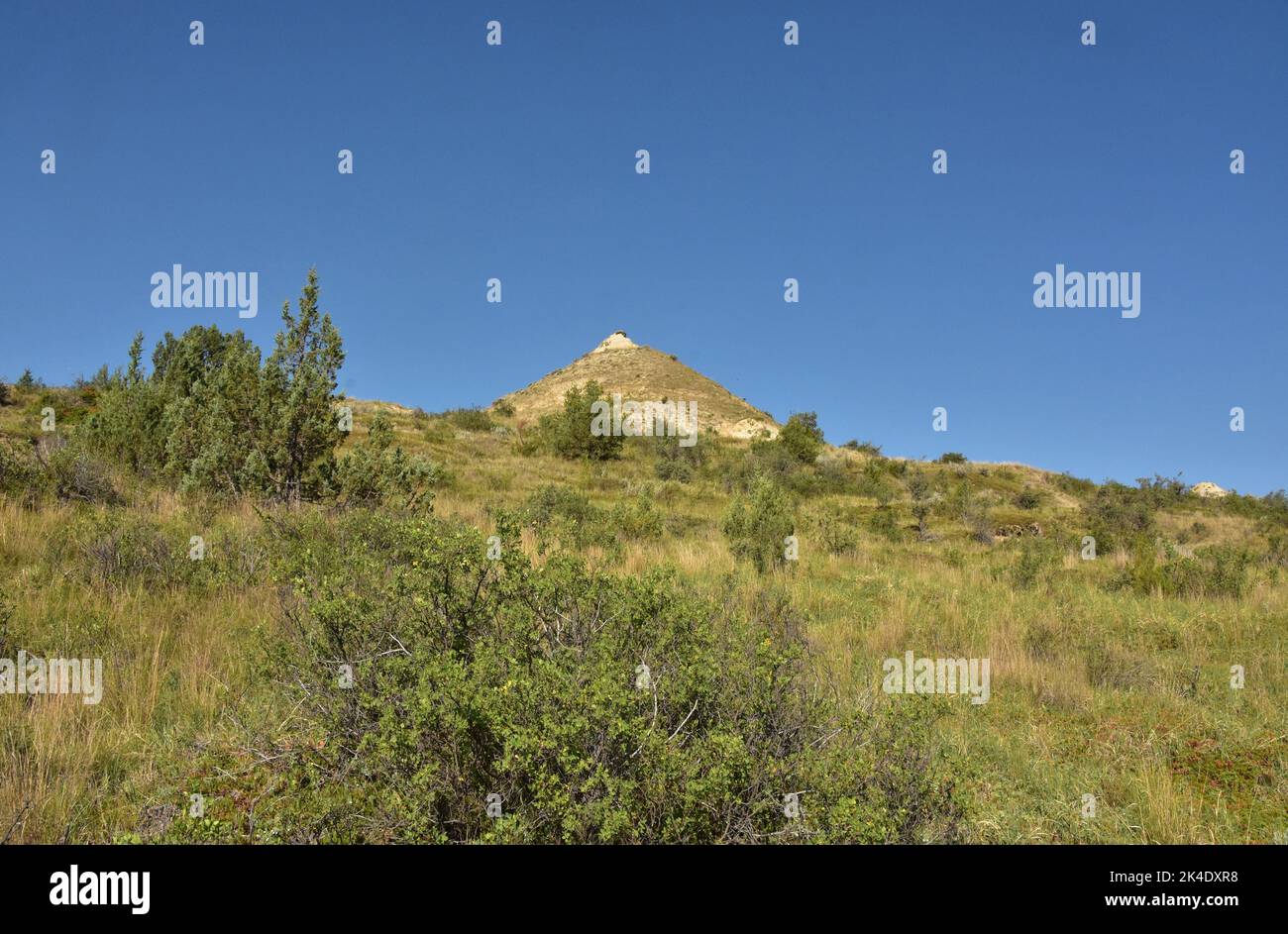 Pyramid sandstone rock formation on top of a hill in the badlands Stock ...
