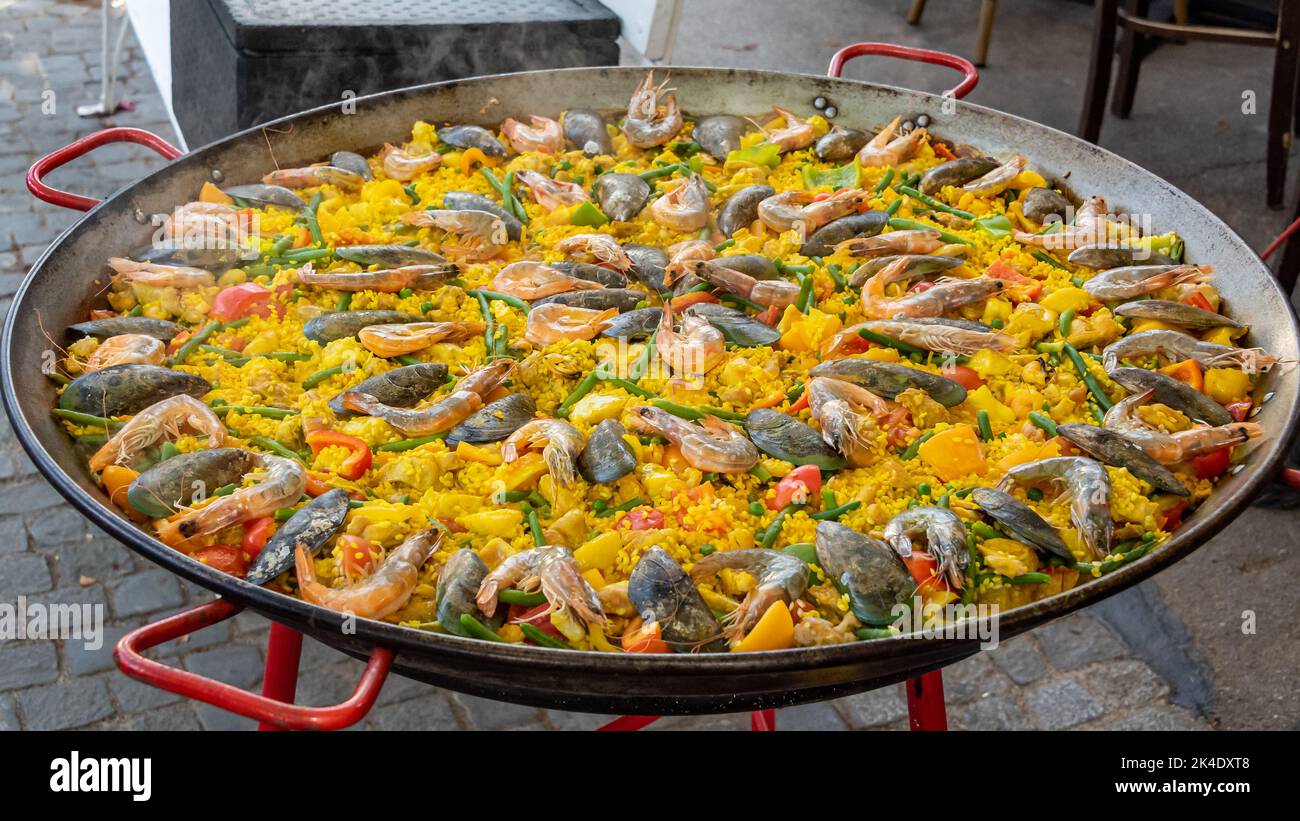 Traditional Spanish paella with rice, mussels, shrimp in a large ...