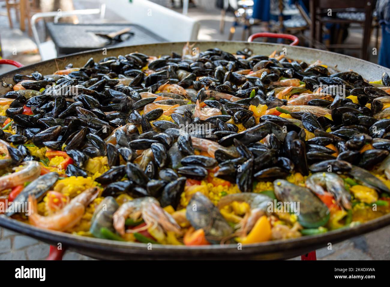 Traditional Spanish paella with rice, mussels, shrimp in a large ...