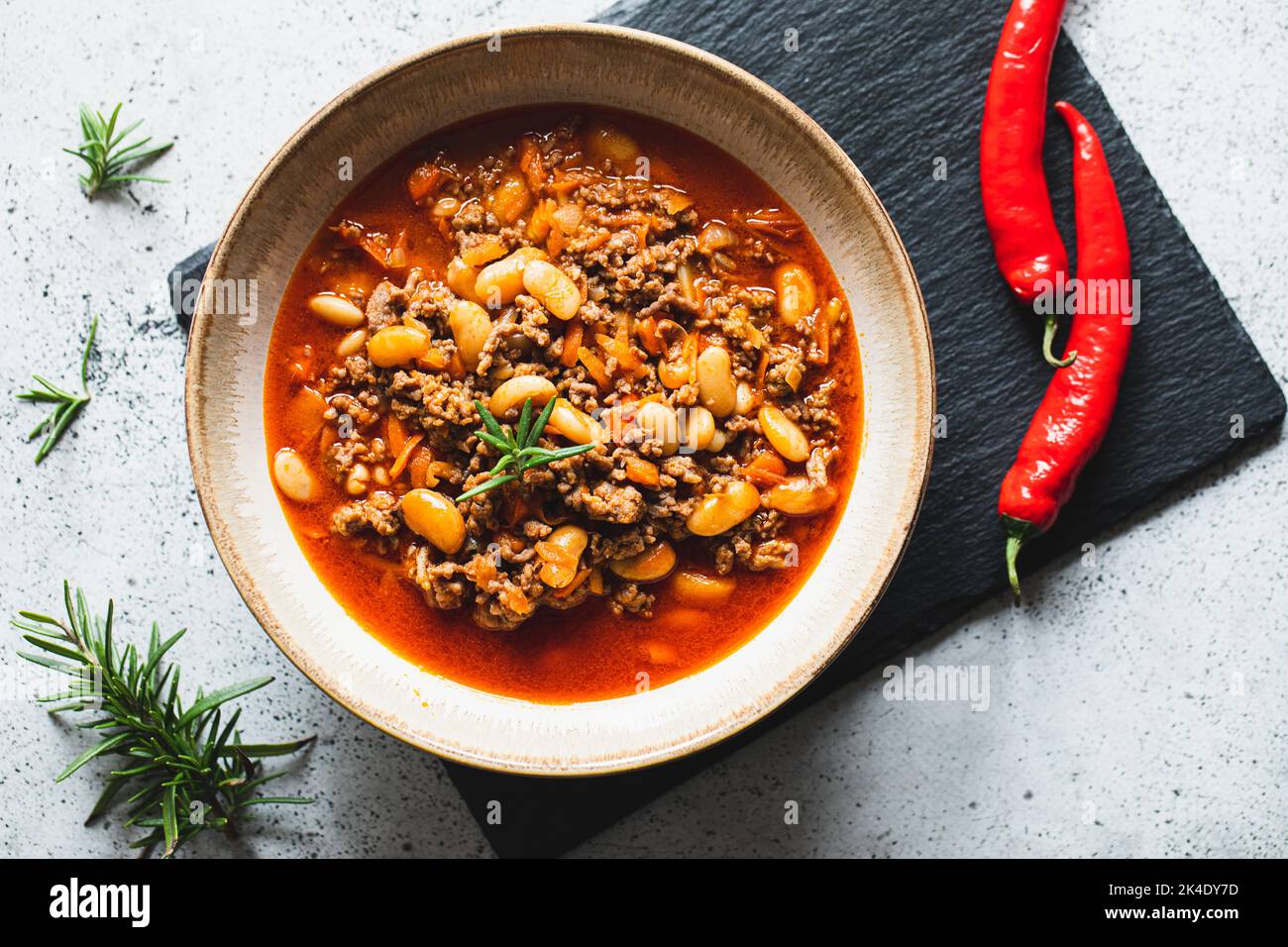 Chili Con Carne in bowl on light grey stone or concrete background ...