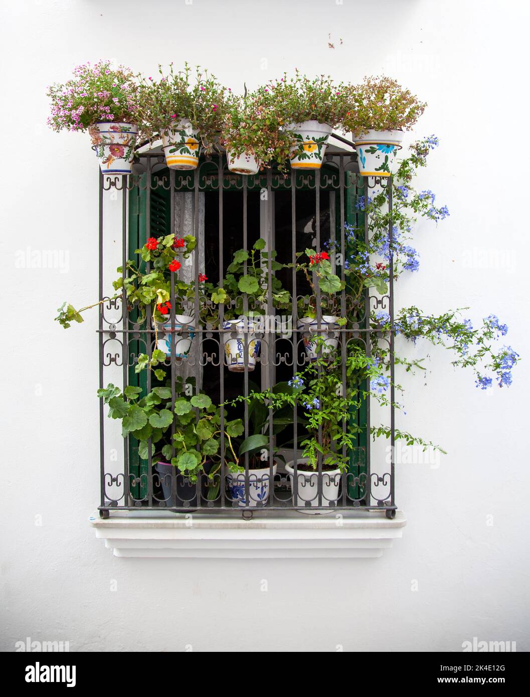 Flower Pots Hanging From Window in Sitges, Spain Stock Photo - Alamy
