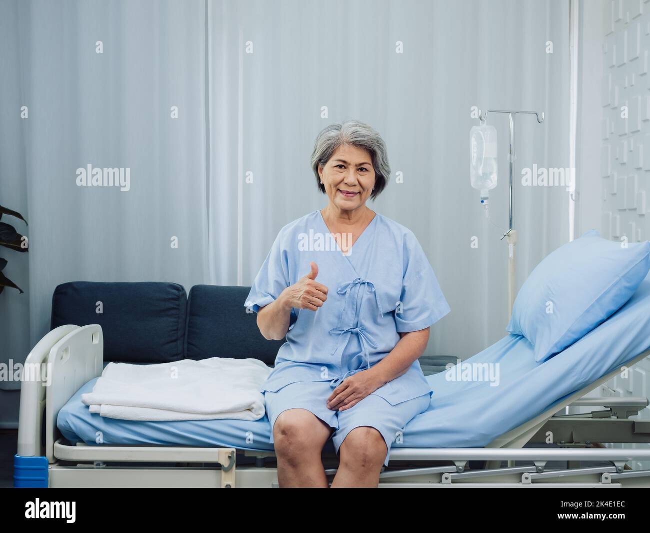 Happy smile Asian elderly old female patient with knee surgery in light ...