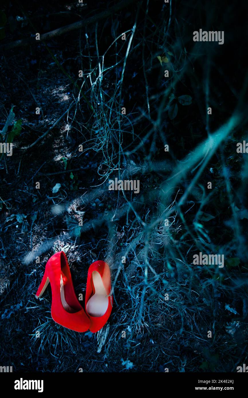 Abandoned red heels in nature Stock Photo - Alamy