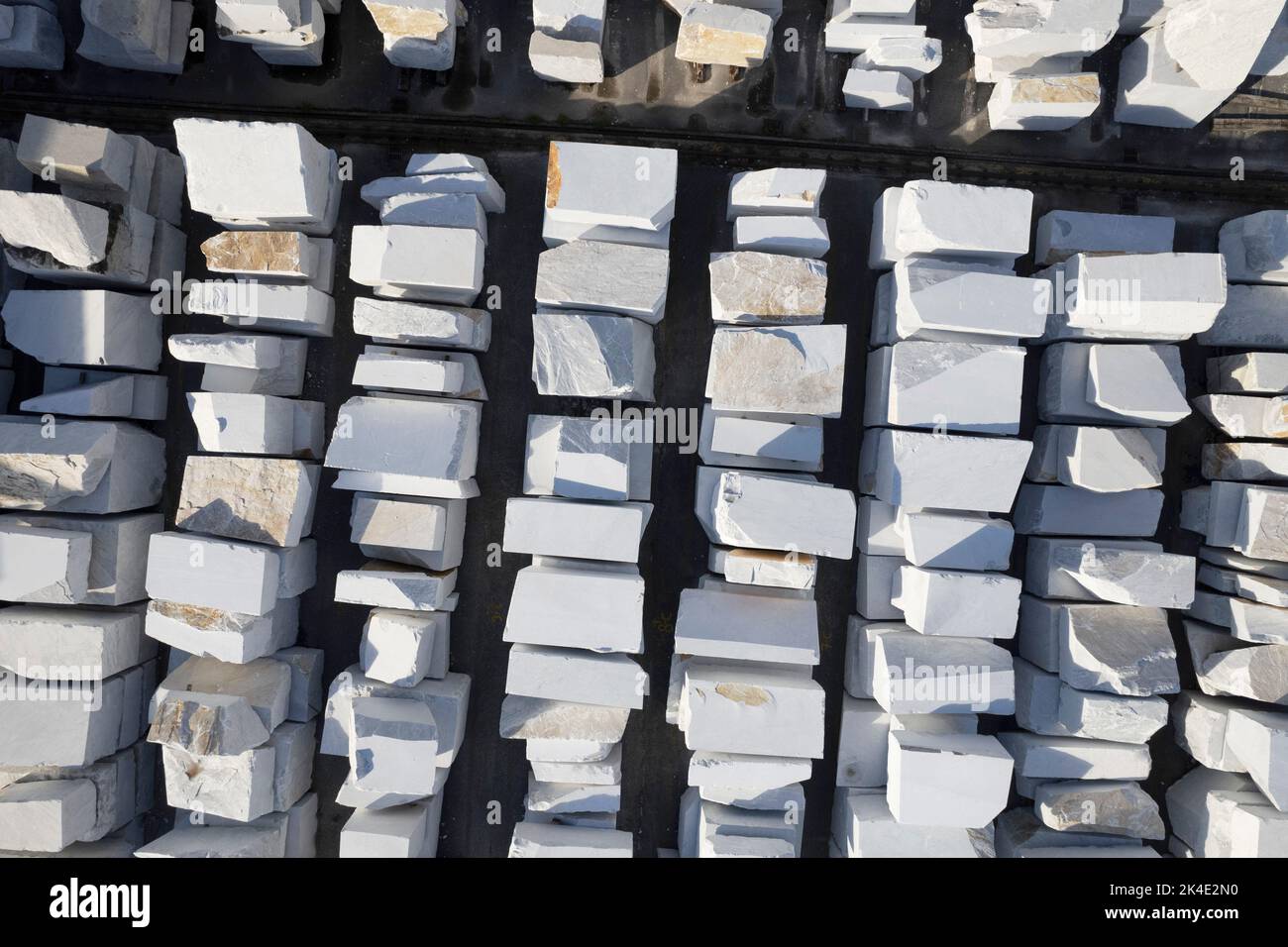 Aerial photographic documentation of a warehouse of white marble blocks ...