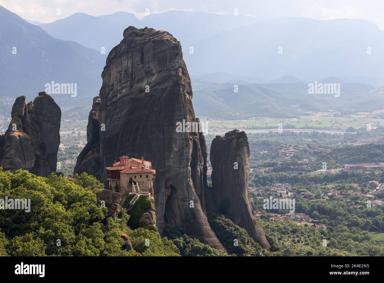 Meteora is extensive complex of gigantic sandstone rocks shadowing ...
