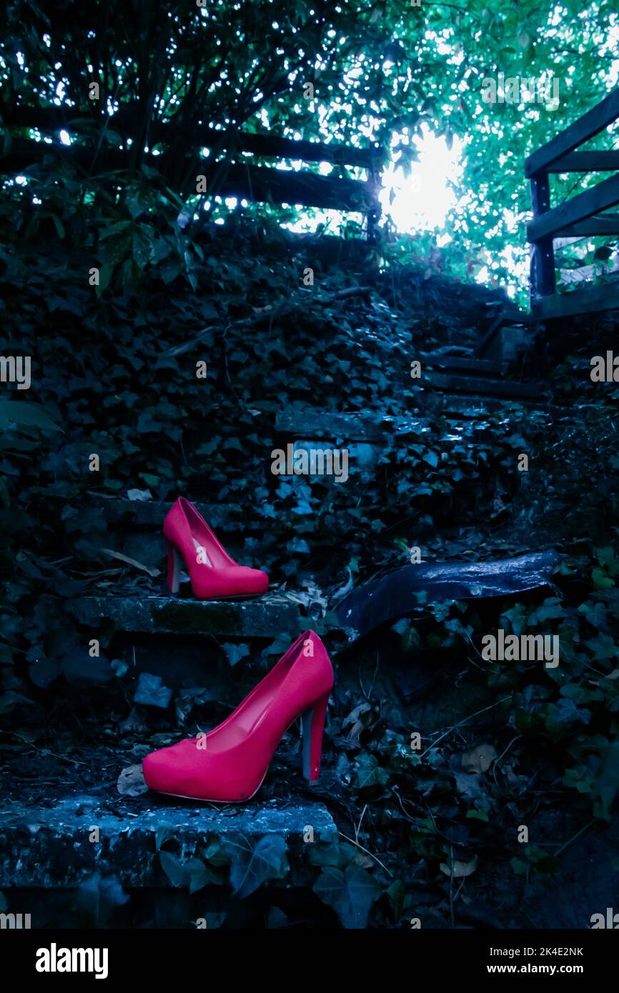 Abandoned red heels in nature Stock Photo - Alamy