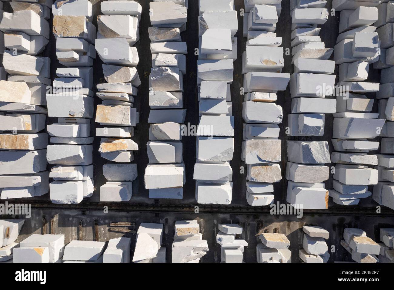 Aerial photographic documentation of a warehouse of white marble blocks ...