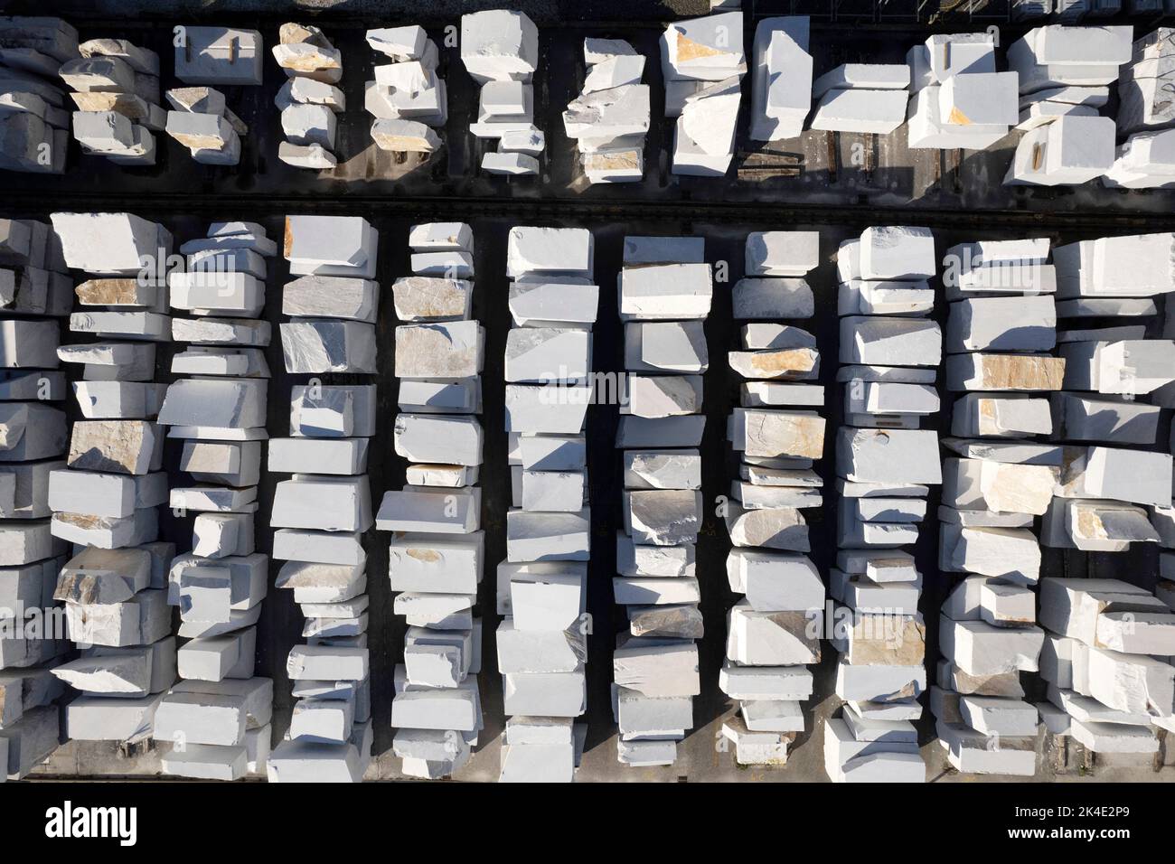 Aerial photographic documentation of a warehouse of white marble blocks ...