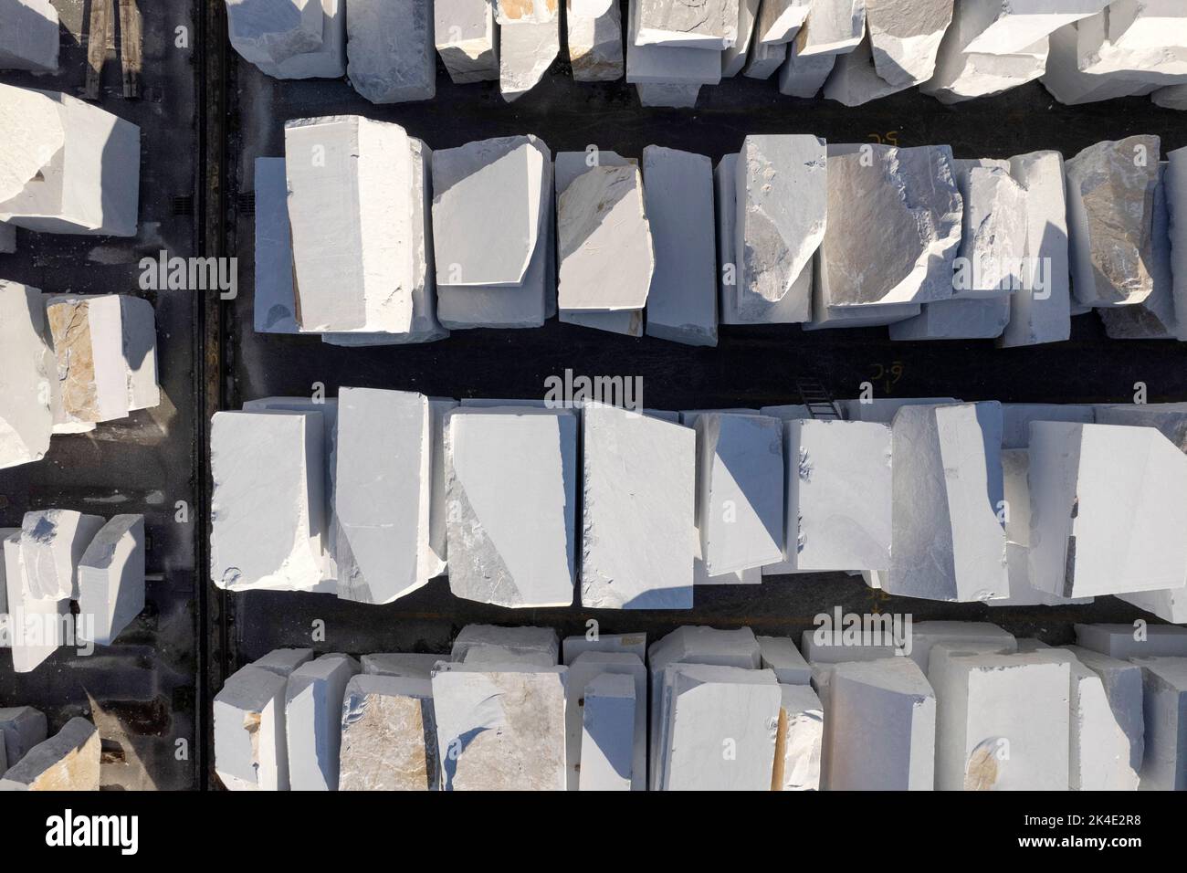 Aerial photographic documentation of a warehouse of white marble blocks ...