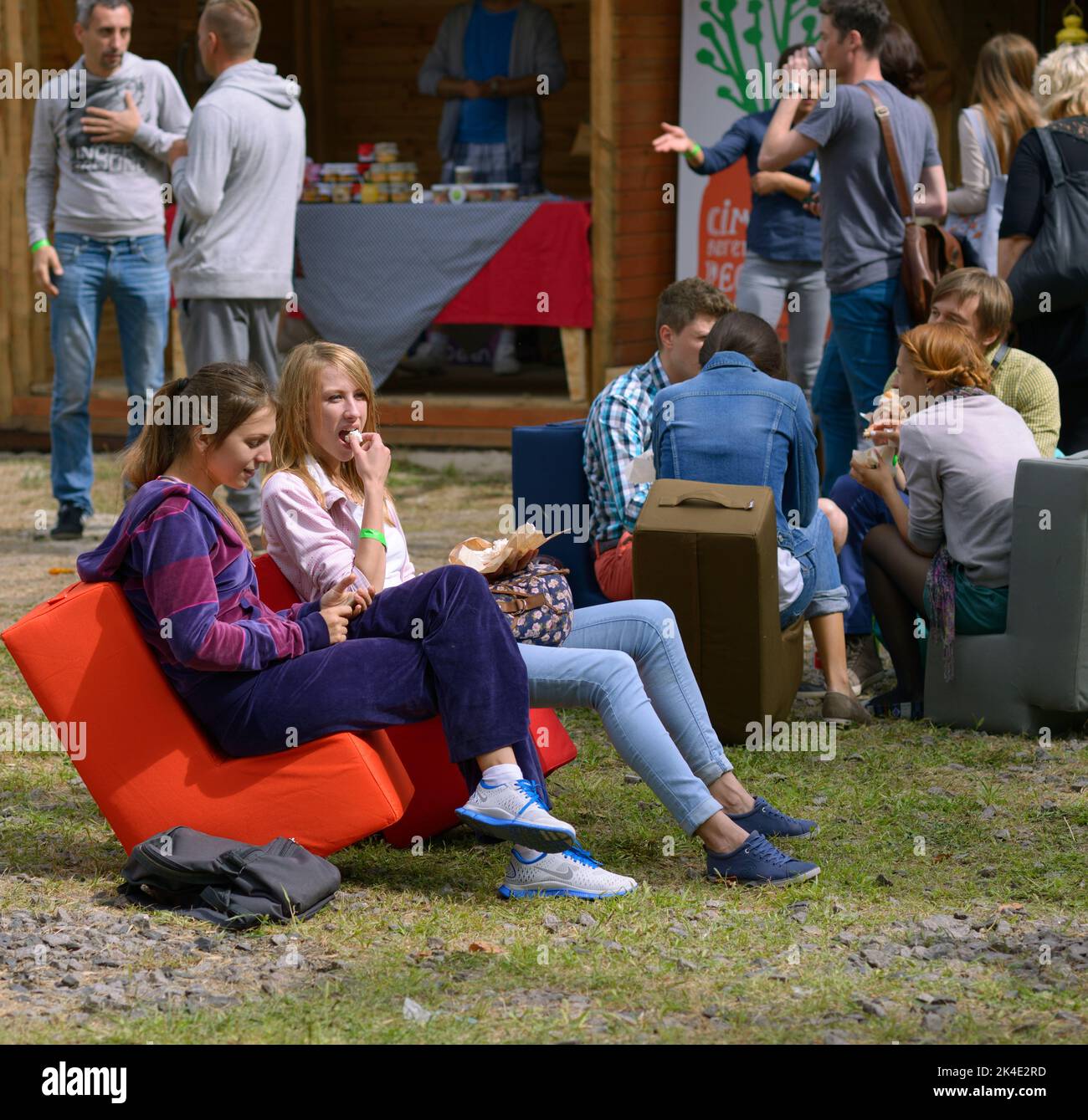 Young people sitting on couches at the lounge zone outdoor ...