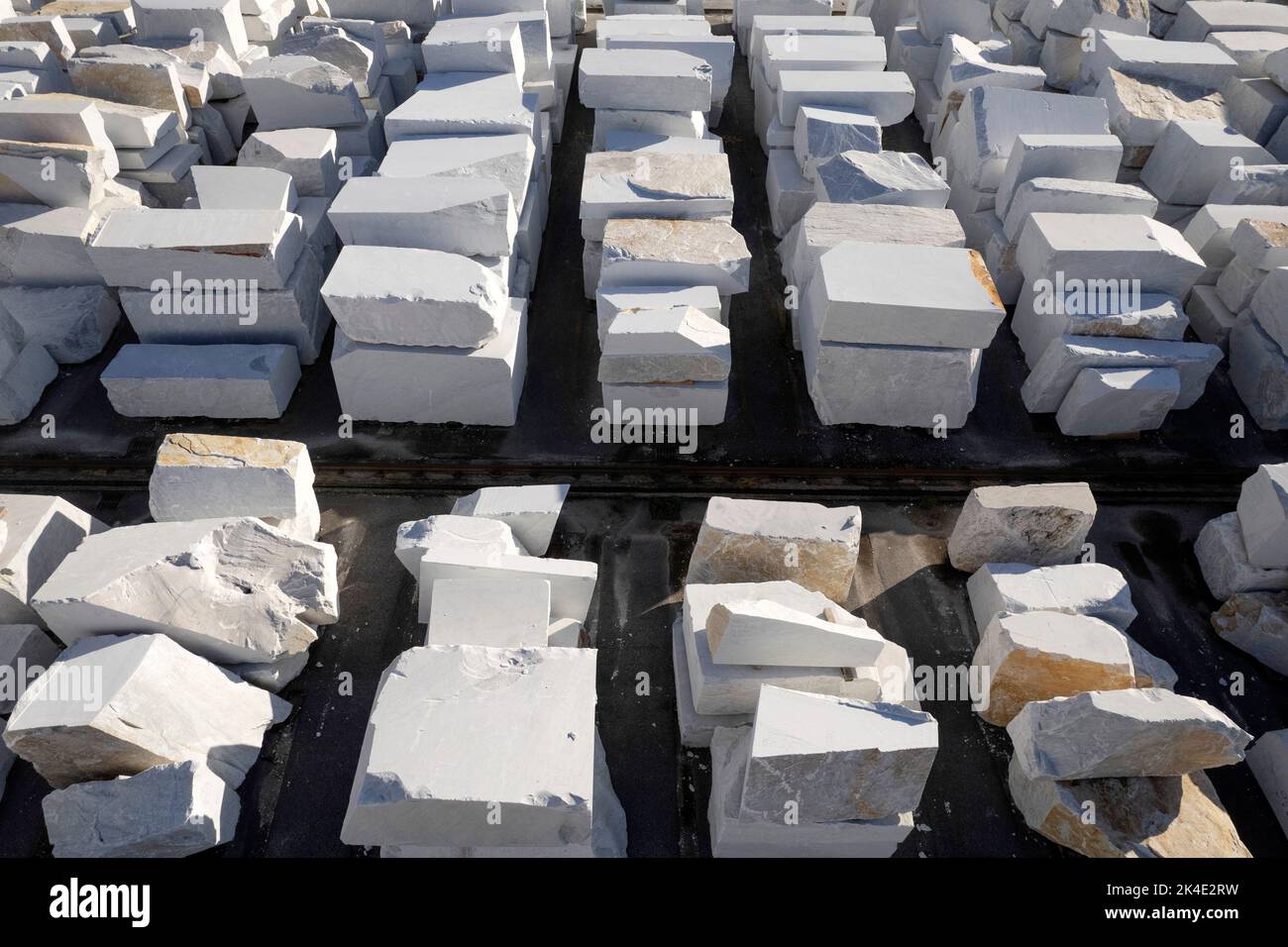 Aerial photographic documentation of a warehouse of white marble blocks ...