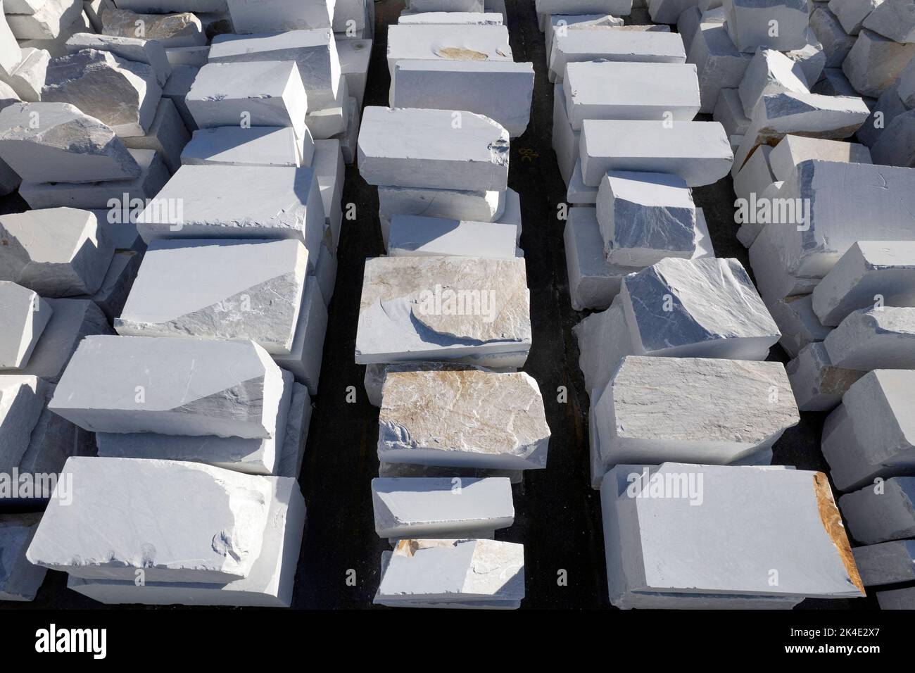 Aerial photographic documentation of a warehouse of white marble blocks ...