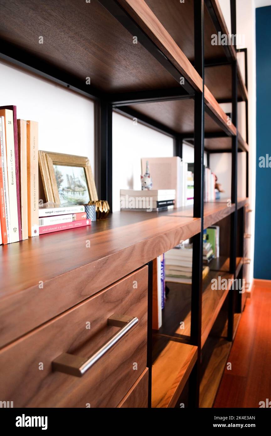 metal and wood bookcase, with drawers person in front passing Stock ...