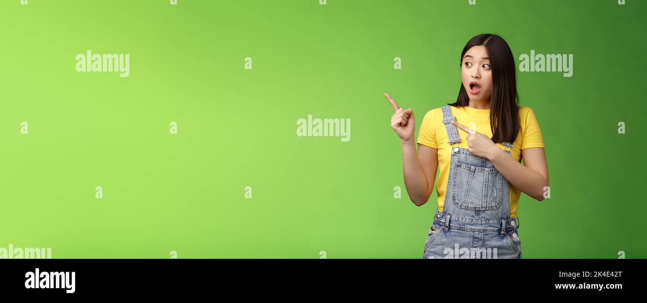 Shocked gasping alarmed pretty asian girl drop jaw impressed, turn ...