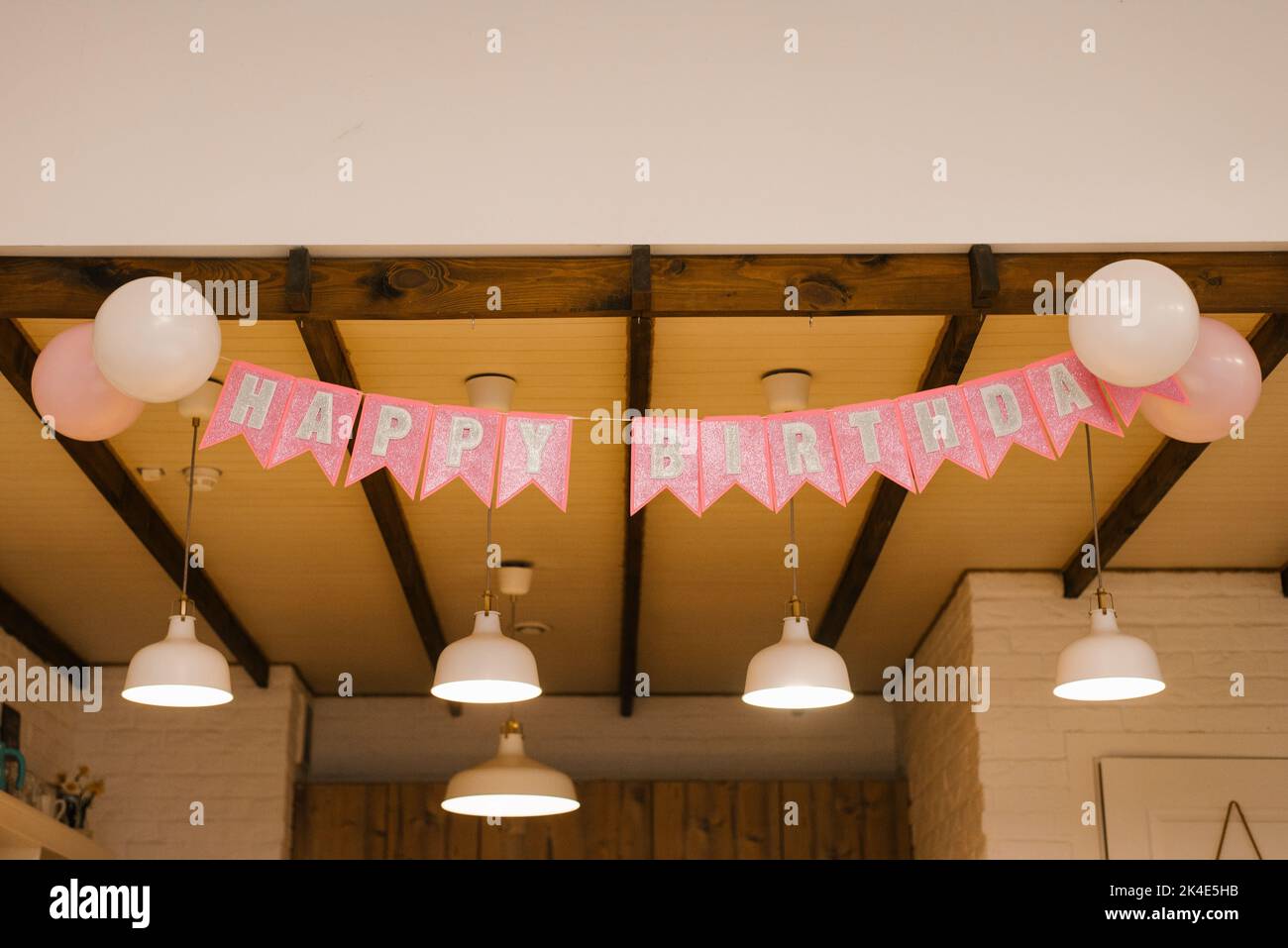 Festive birthday flags hang above the ceiling in the kitchen Stock ...